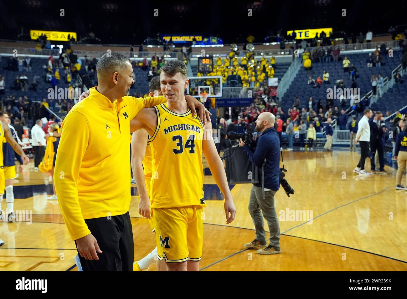Michigan head coach Juwan Howard walks off the court with forward ...