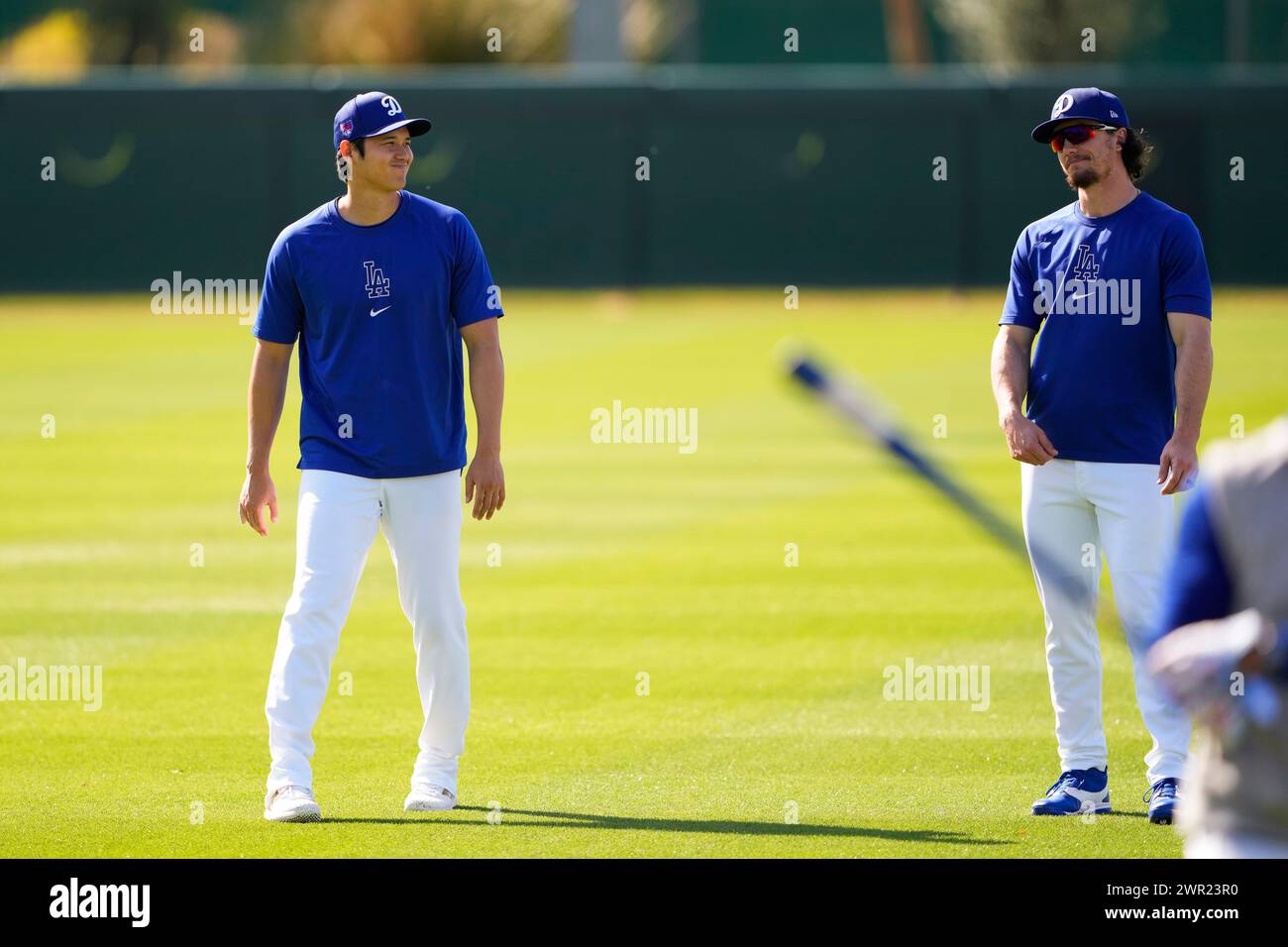 Los Angeles Dodgers designated hitter Shohei Ohtani stands with James ...