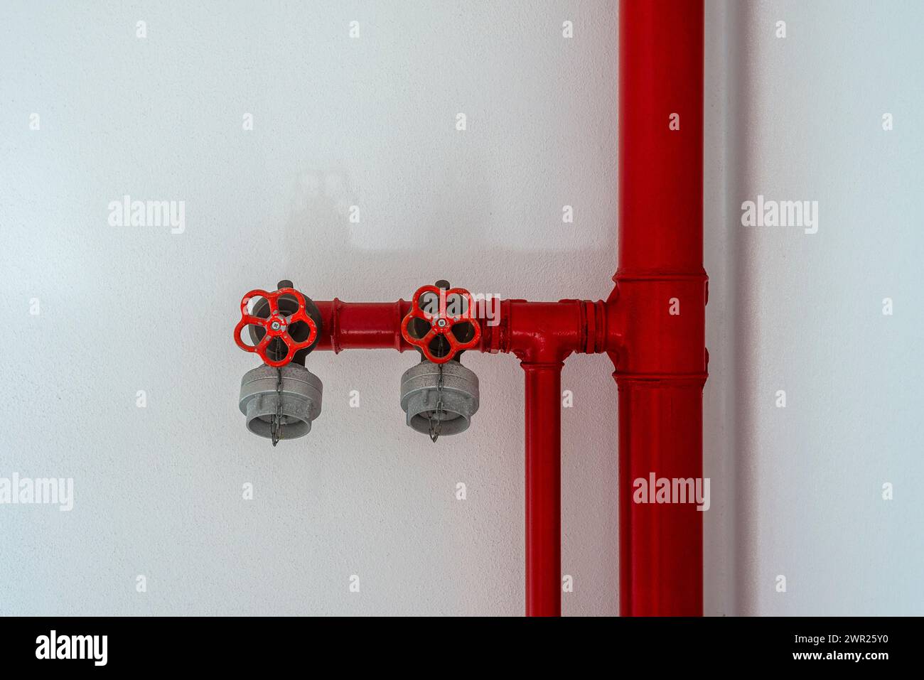Red fire hydrant pipes and valves in a building Stock Photo - Alamy