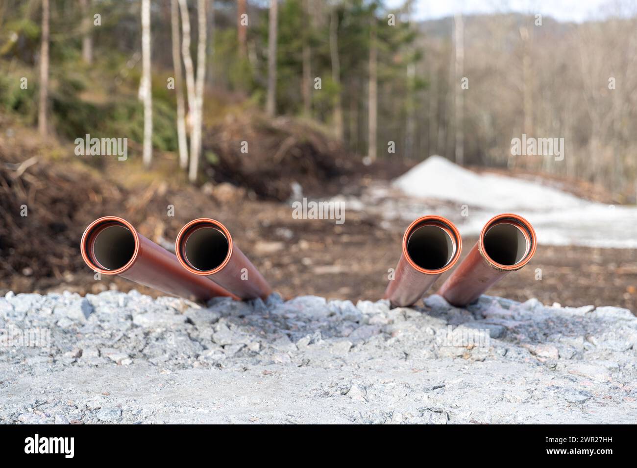 Orange plastic waste water pipes laying on construction site Stock ...