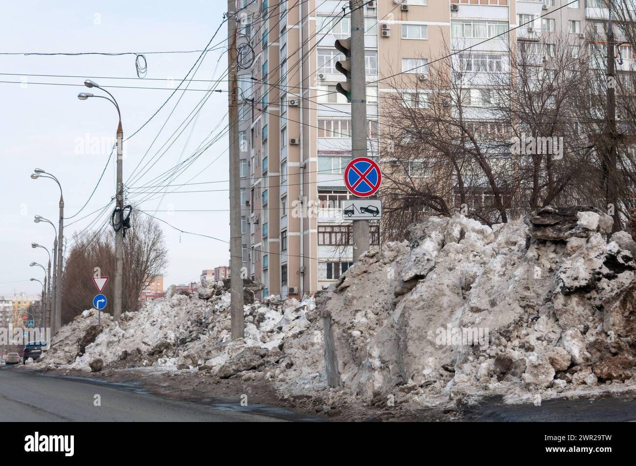 Consequences of snowfall A huge mountain of snow on the roadway Samara ...