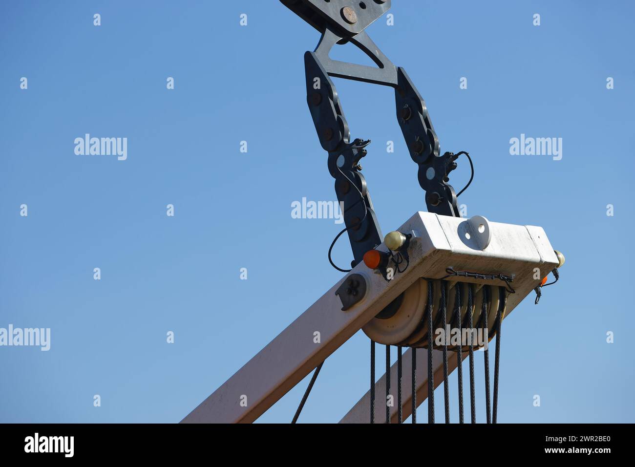 Mobile crane close up of wire ropes and pulley block with steel ...