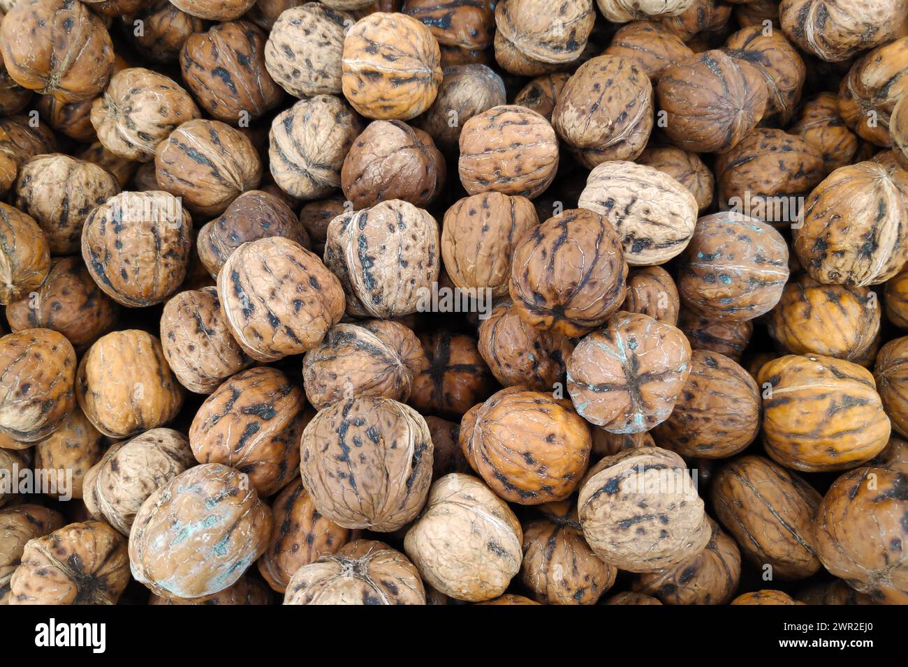 Close-up on a stack of walnuts on a market stall Stock Photo - Alamy