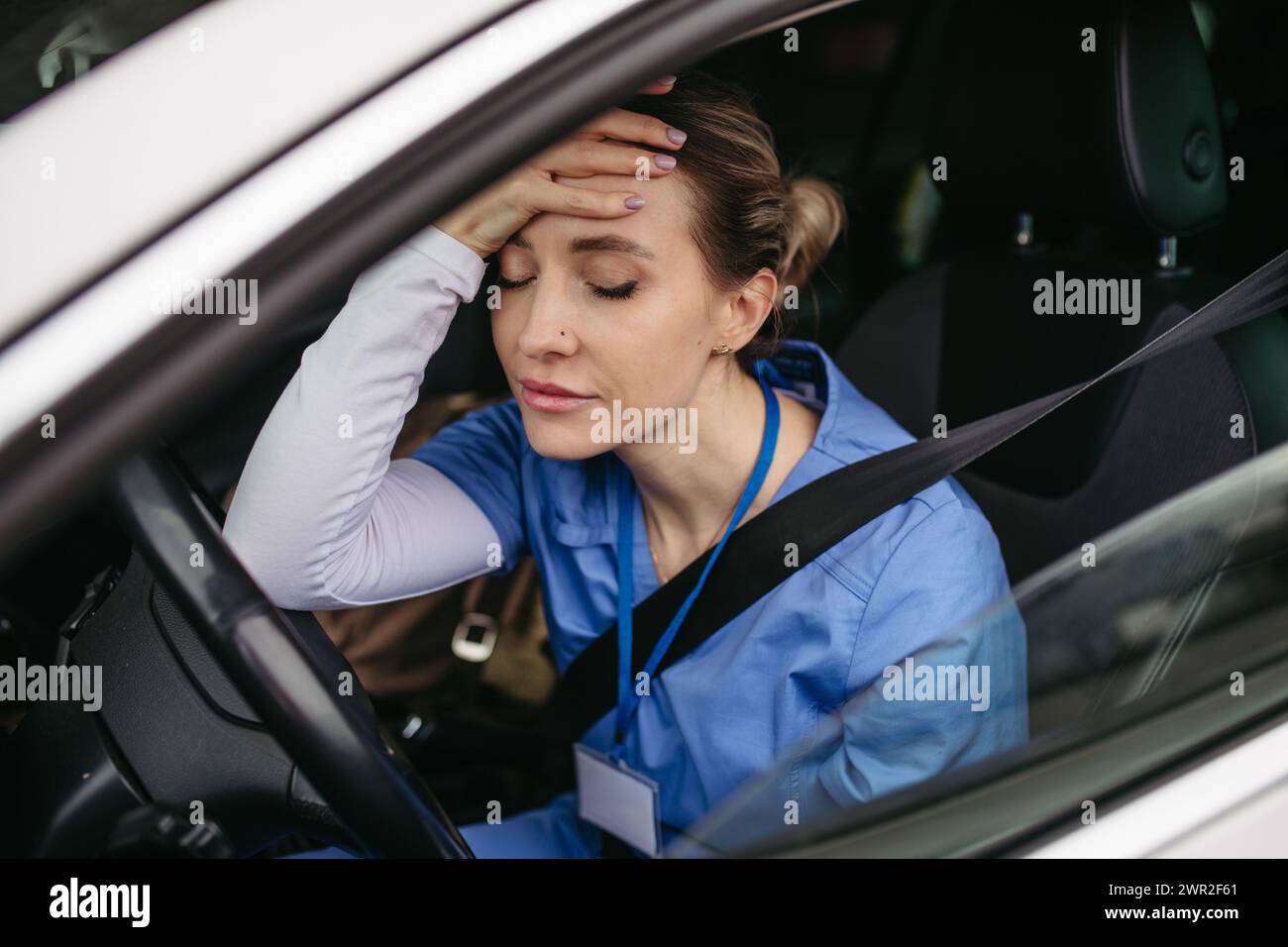 Nurse crying in car, going home after hard work day. Female doctor ...