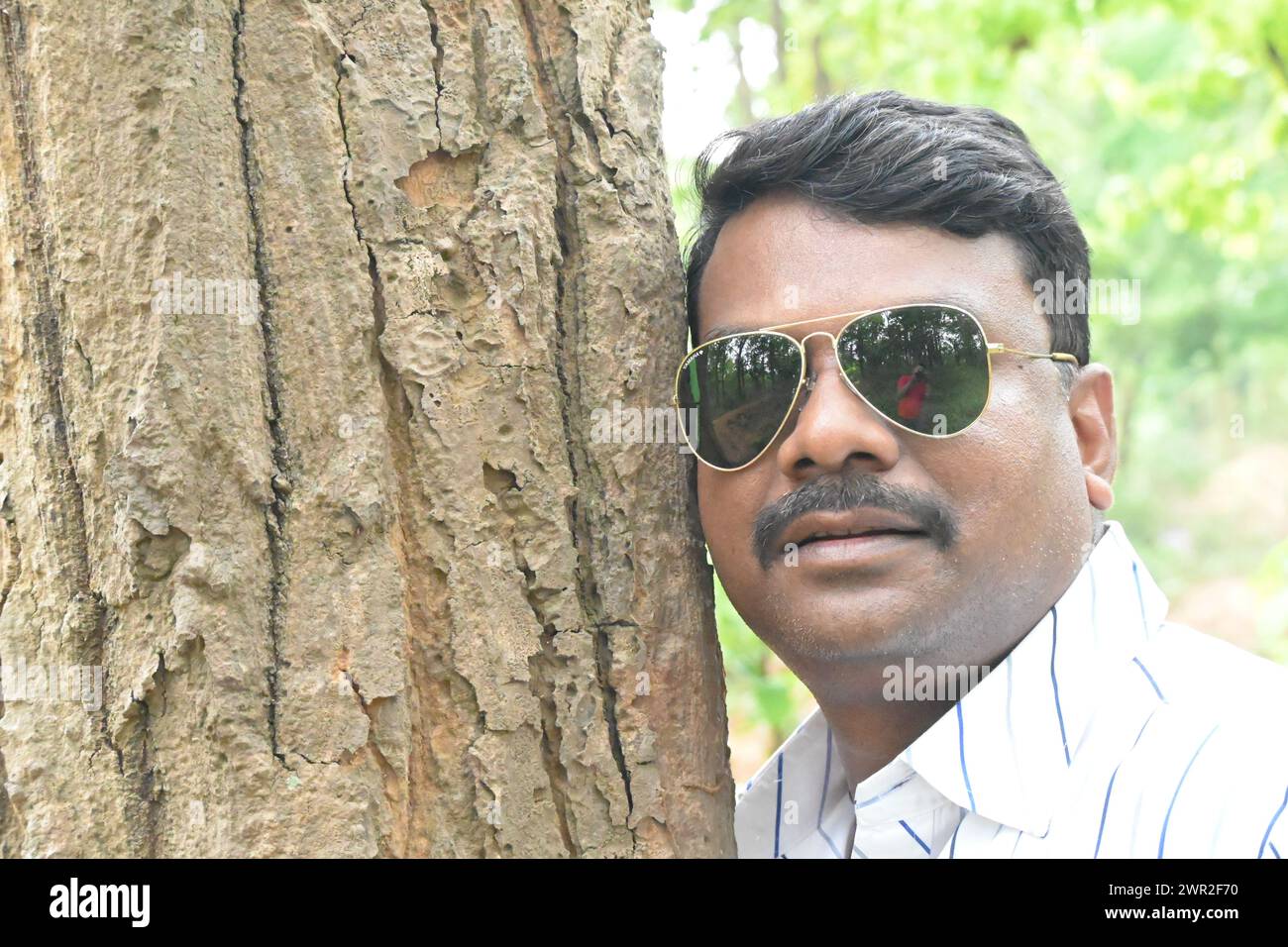Man standing near tree hi-res stock photography and images - Alamy