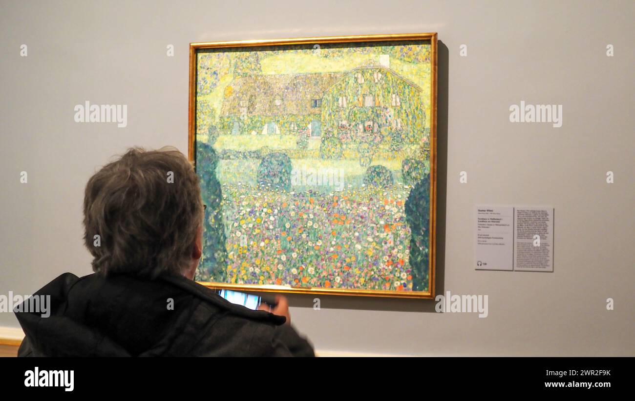 A visitor looks at the paintings of Gustav Klimt, Country House ...