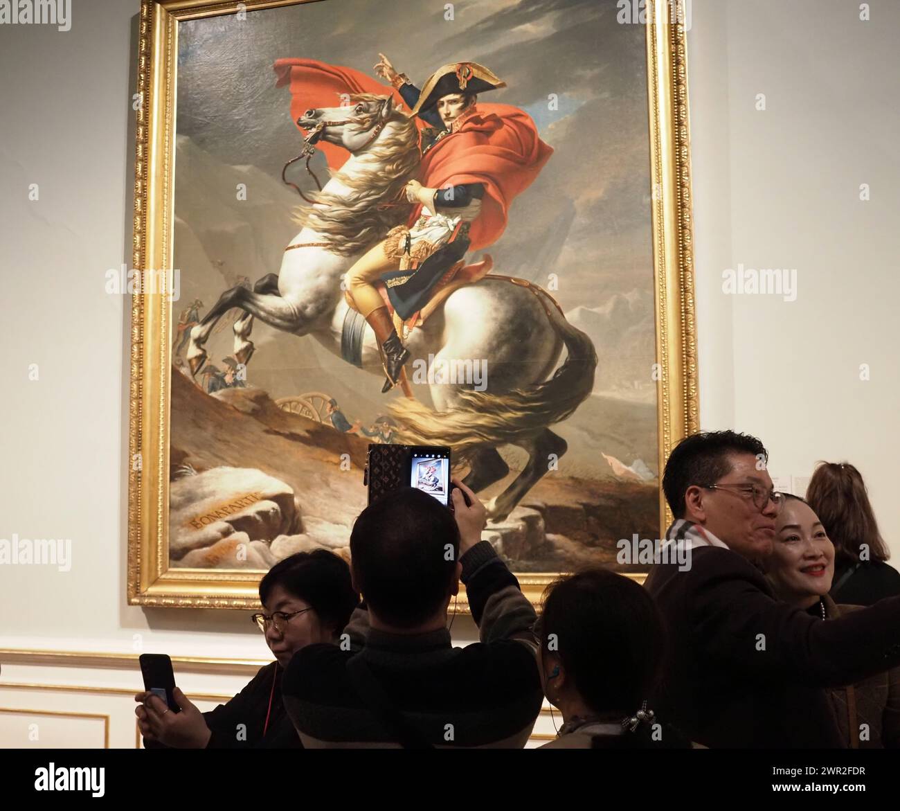 Visitors view paintings of Jacques-Louis David Napoleon at the Great St ...