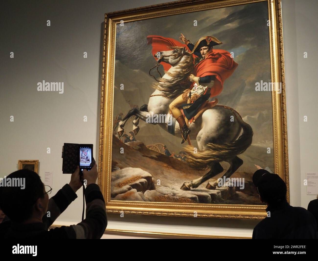 A visitor takes photos of the paintings of Jacques-Louis David Napoleon ...
