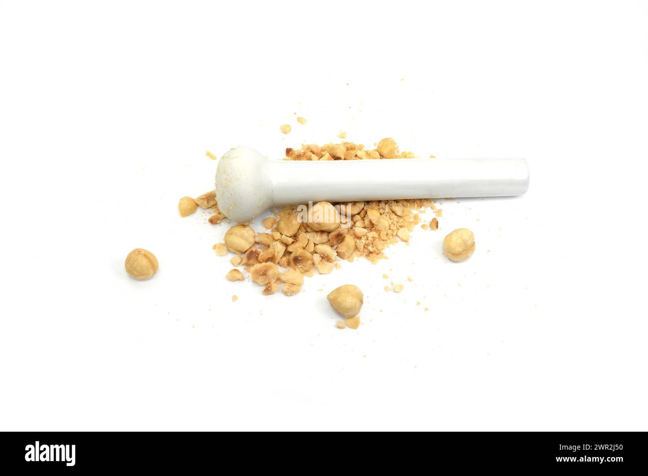 Ground, milled, crushed or granulated hazelnut pile isolated on white ...