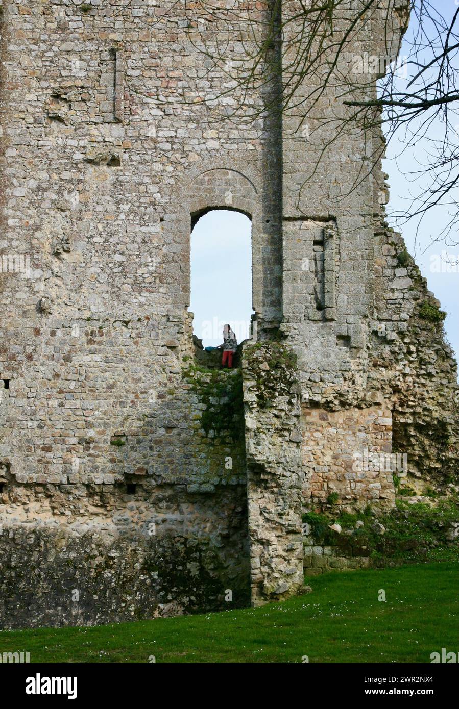 A view of a young girl climbing the walls of the chateau, at Domfront ...
