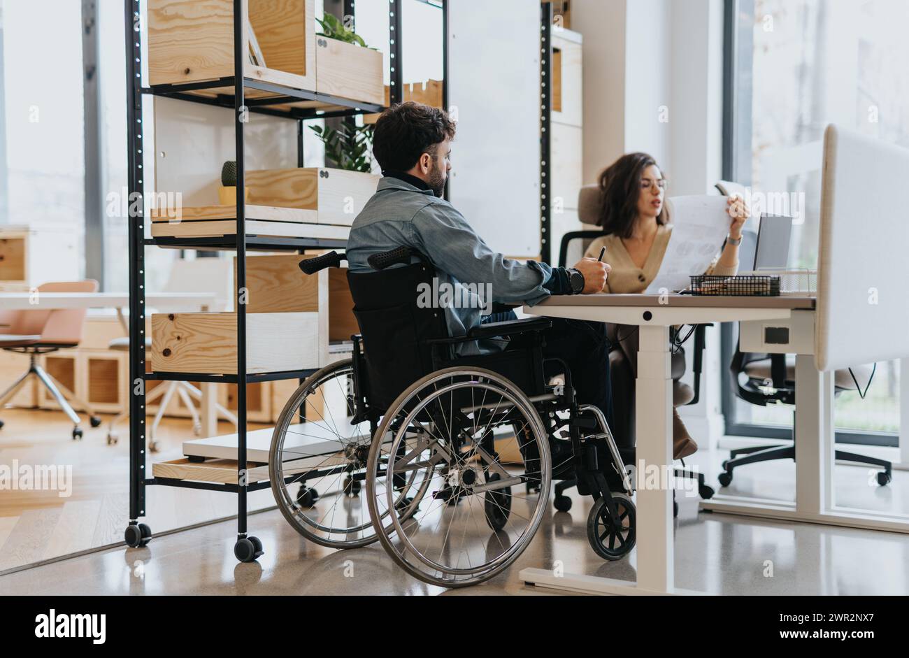 Woman in wheelchair collaborating hi-res stock photography and images ...