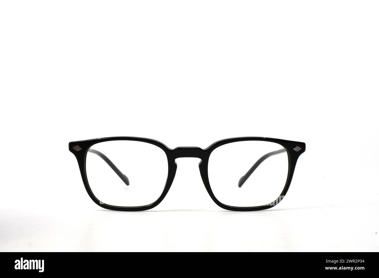 Pair of black frame glasses isolated on a plain white background. Copy ...