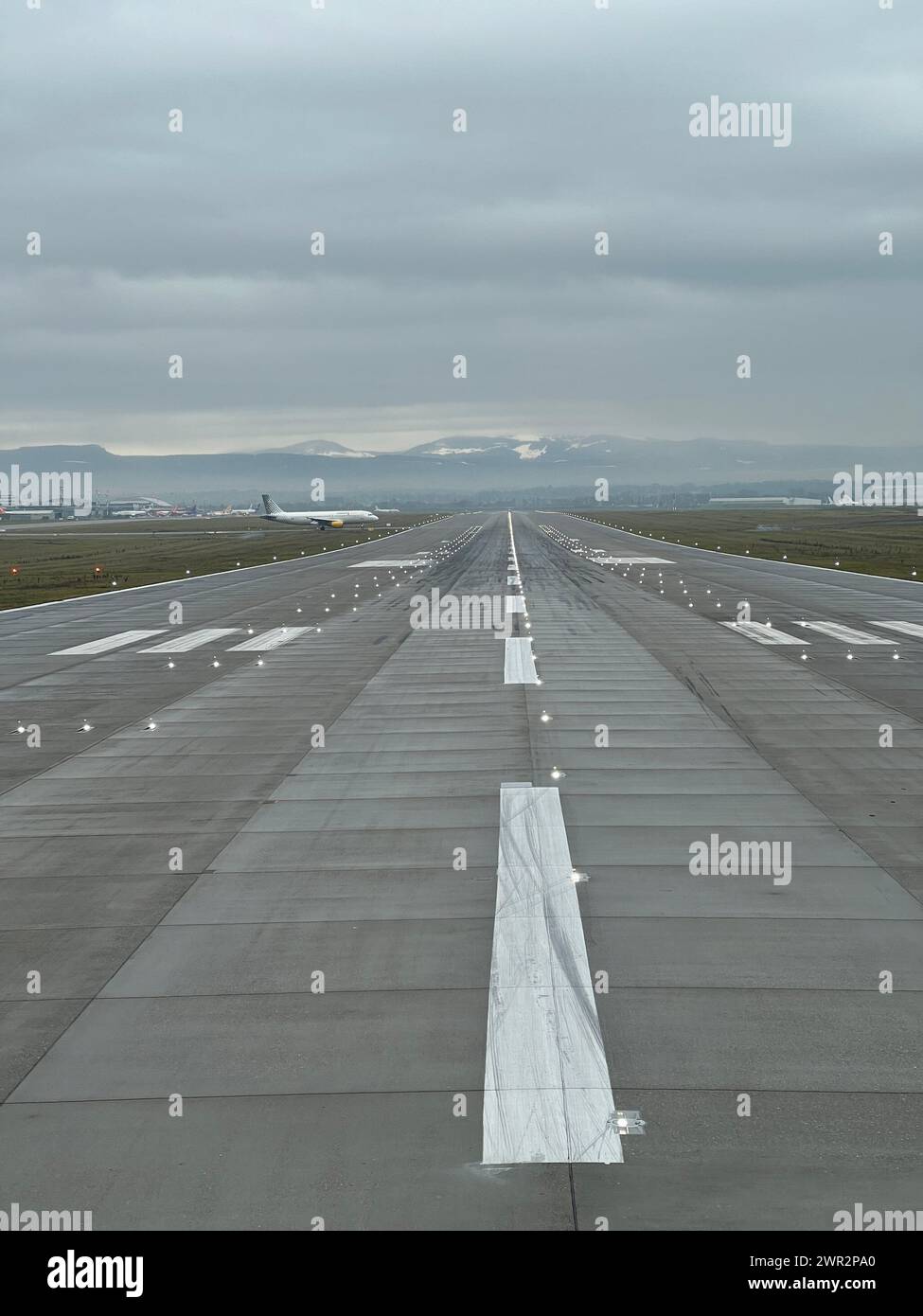 Aircraft about to line up on the runway in front of a plane Stock Photo ...