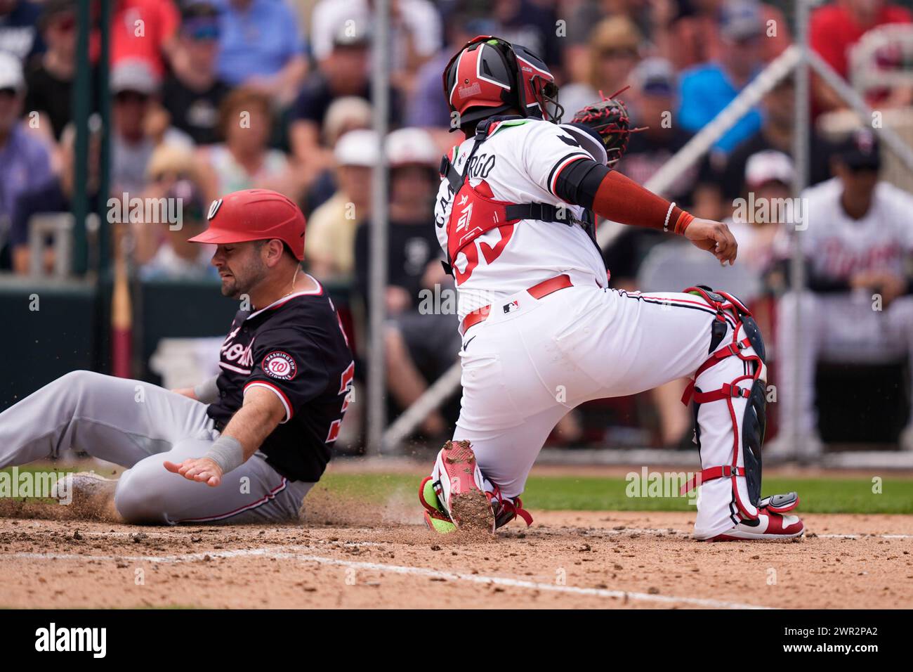 Washington Nationals Jake Alu slides home to score as Minnesota Twins ...