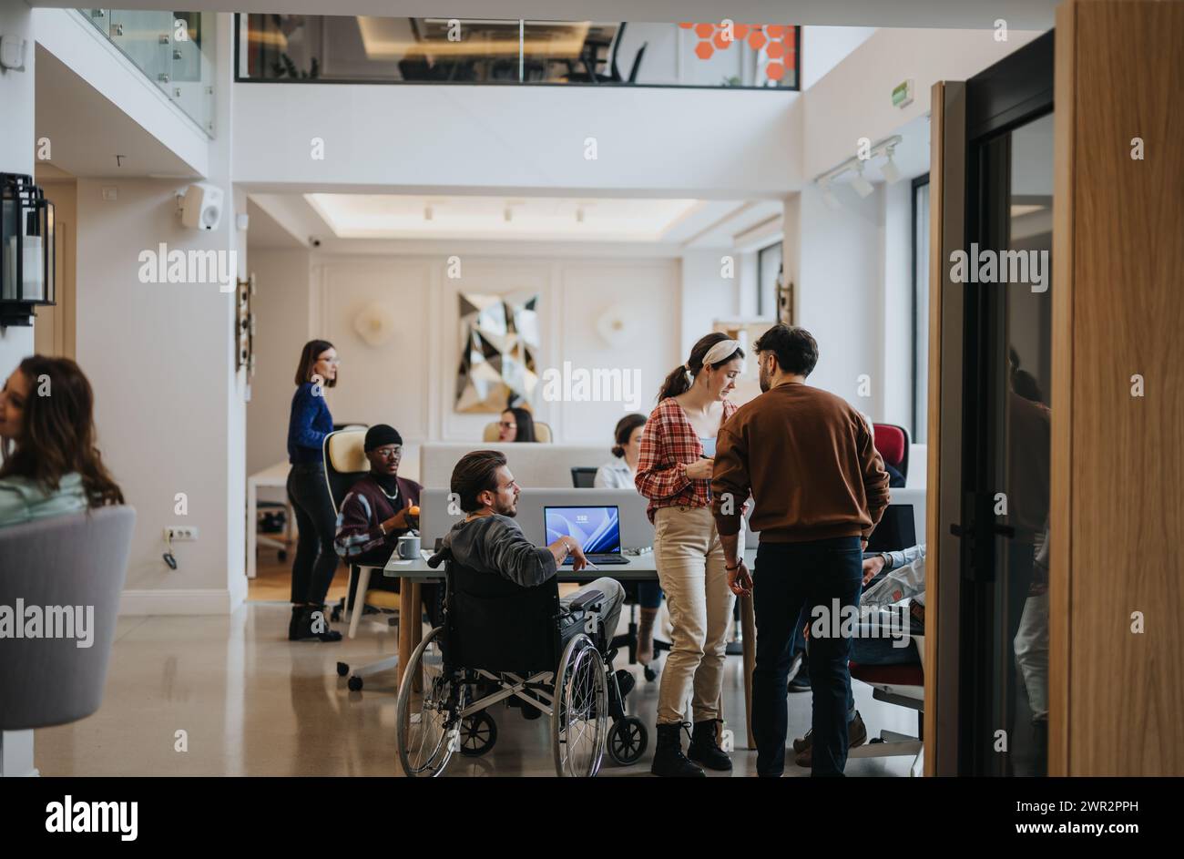 Inclusive modern office environment with diverse team engaging in ...