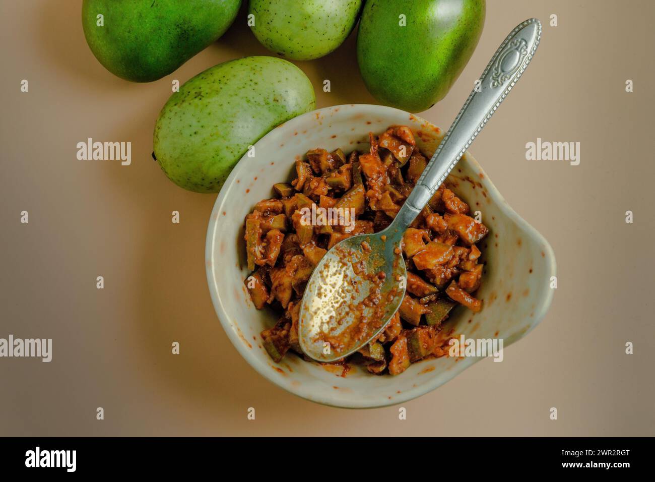 Mango pickle is a spicy condiment made with raw mango, spice powders ...