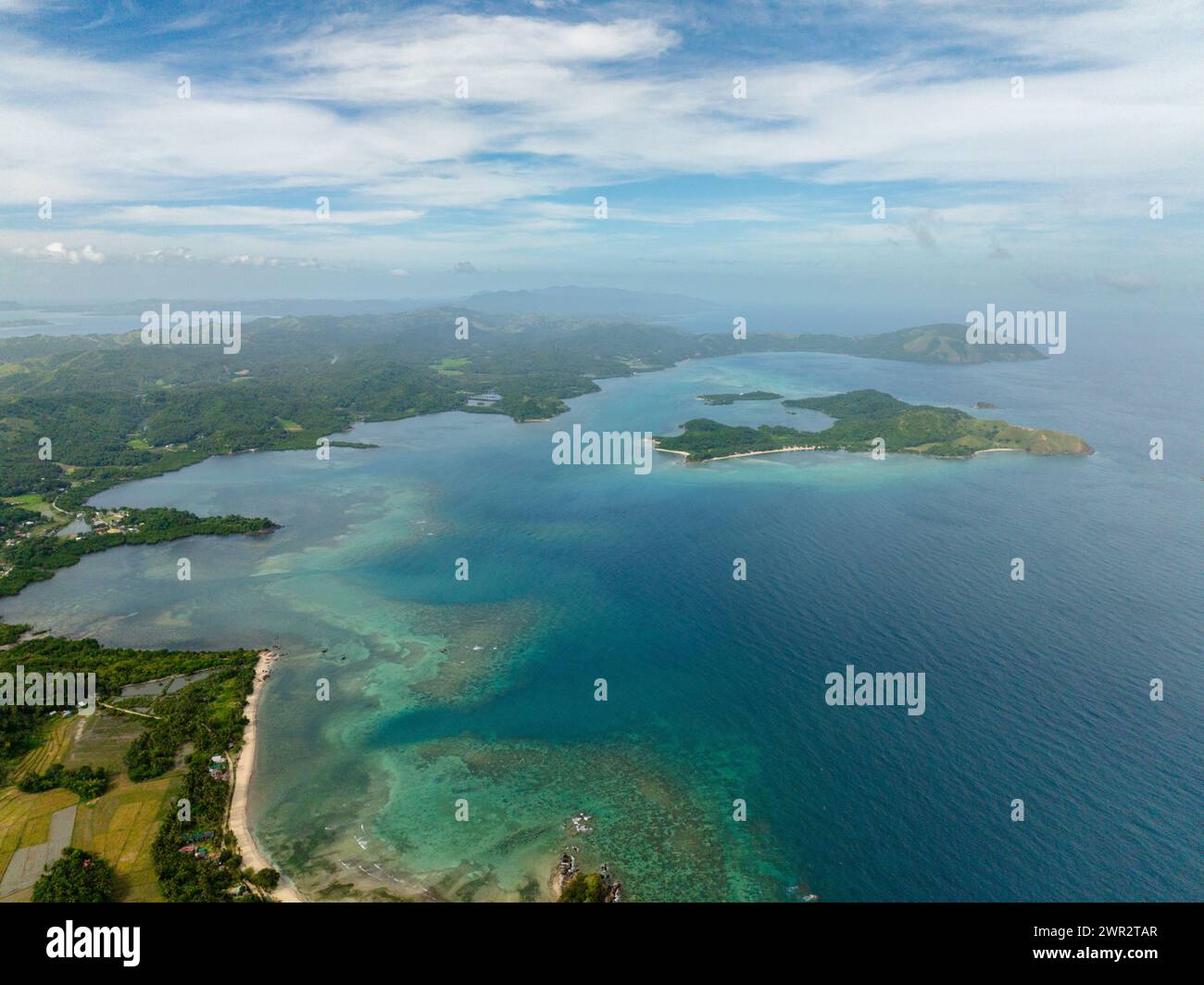 Farmland in tropical island with turquoise sea water and waves. Santa ...