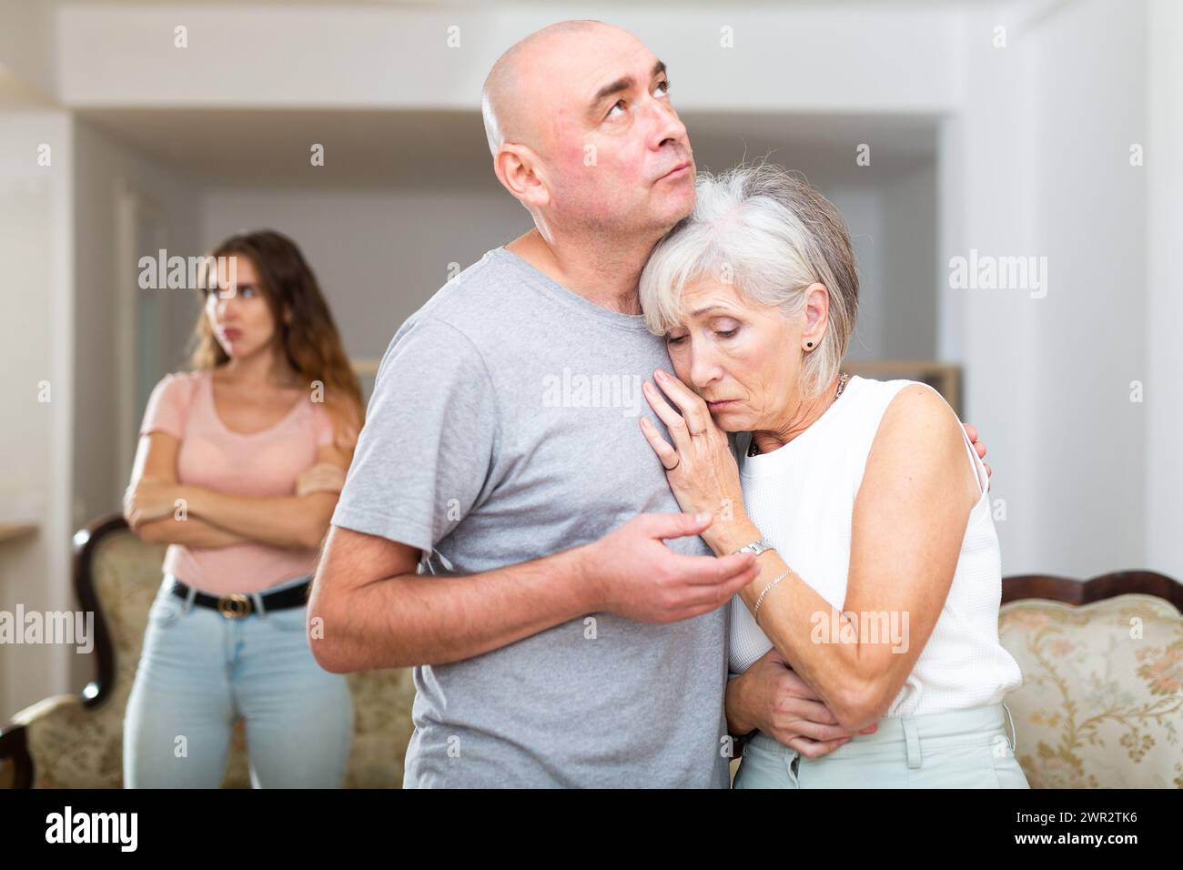 Son soothes mother after her quarrel with daughter-in-law Stock Photo - Alamy