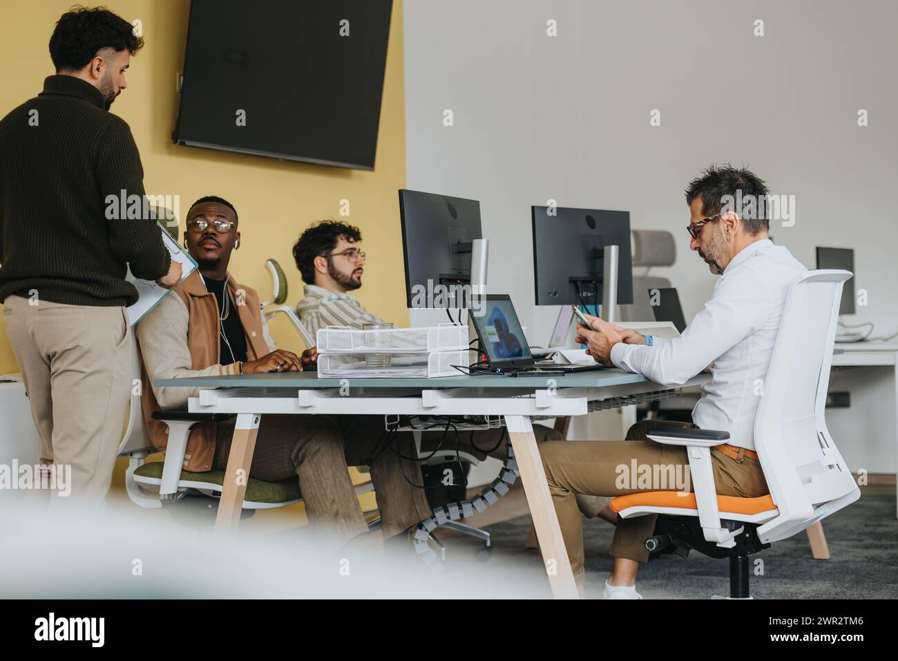 Employees collaborate, analyze data, plan projects, and increase profitability in a modern ...