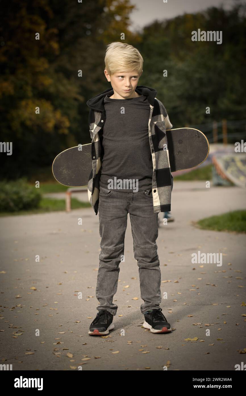Young boy posing outdoor in skate park with skate board Stock Photo - Alamy