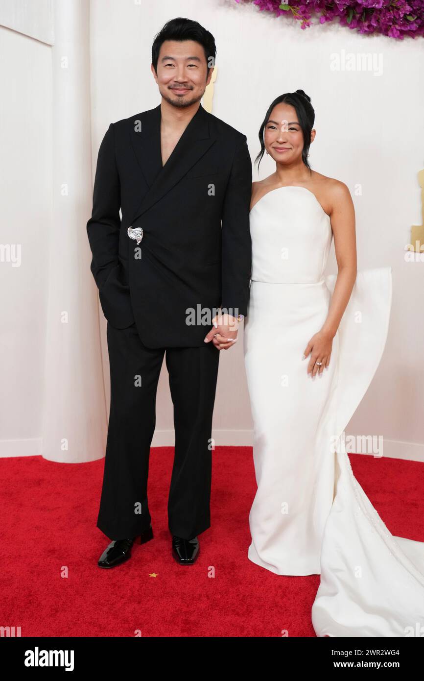 Simu Liu, left, and Allison Hsu arrive at the Oscars on Sunday, March ...