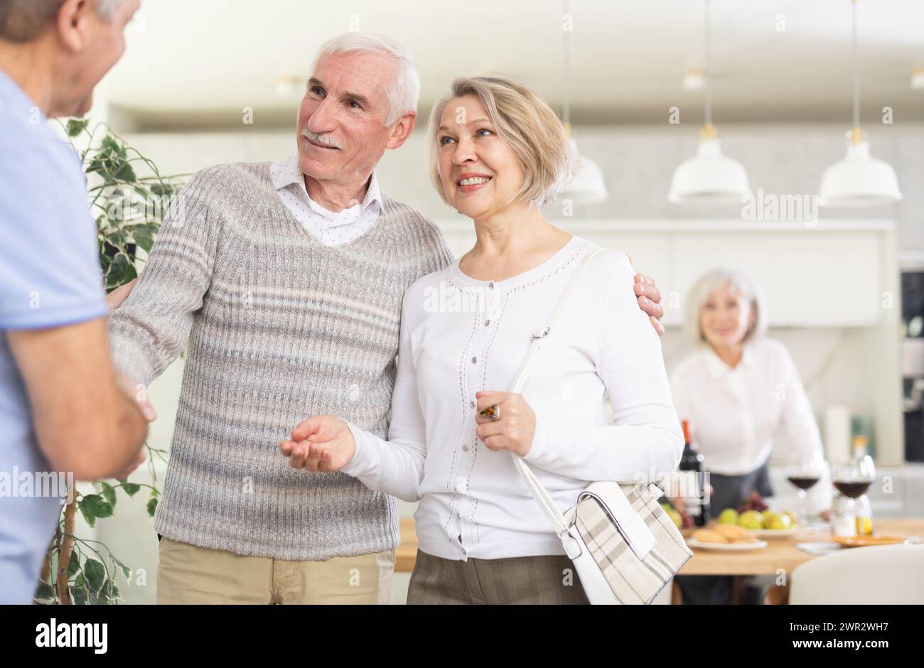 Two elderly couples warmly welcome each other as they gather for a ...
