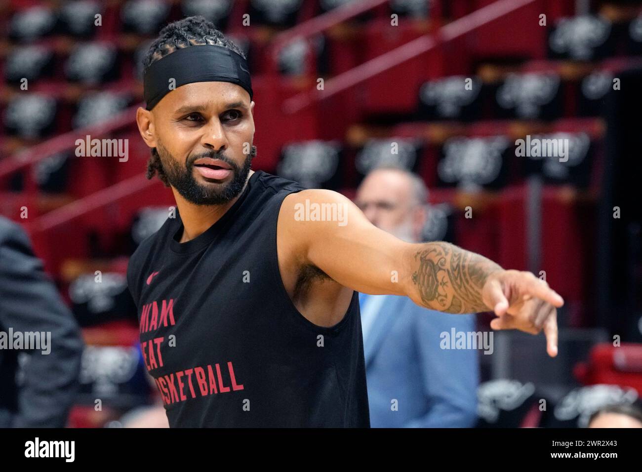 Miami Heat guard Patty Mills gestures to a fan as he warms up before an ...