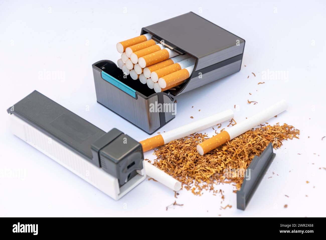 Manual machine for stuffing cigarette casings with tobacco, scattered ...