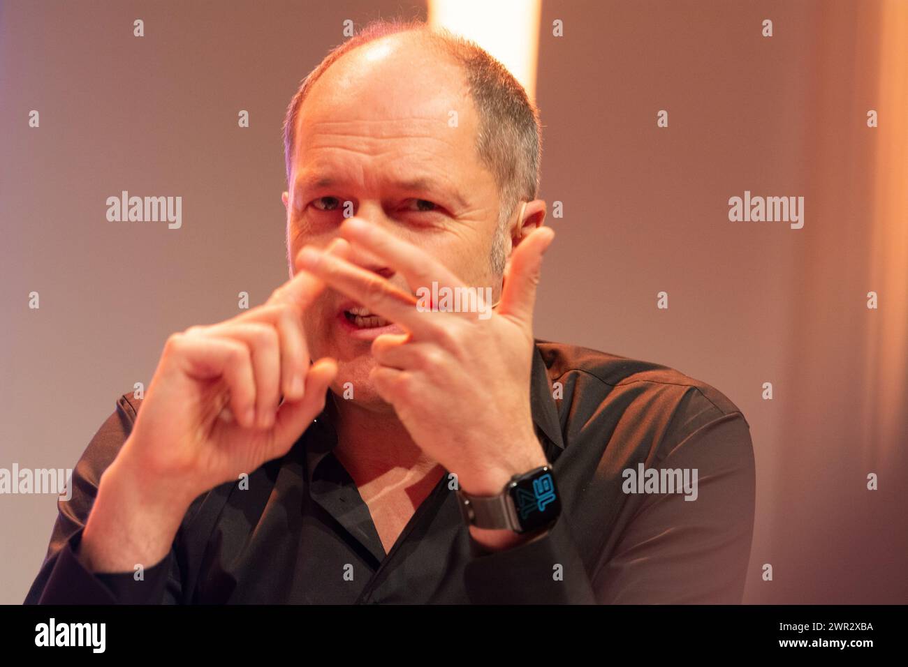 Christoph Chassee, a cameraman, is standing on the stage of Flora Hall ...