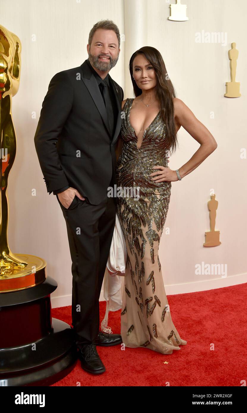 Paul Debevec, left, and Tia Carrere arrive at the Oscars on Sunday ...