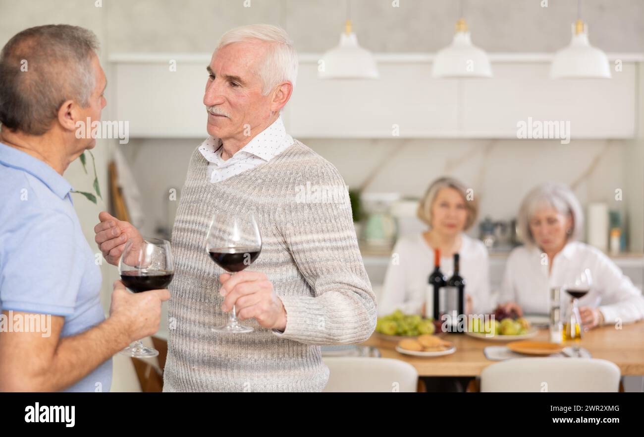 Two elderly men friends talking in kitchen Stock Photo - Alamy