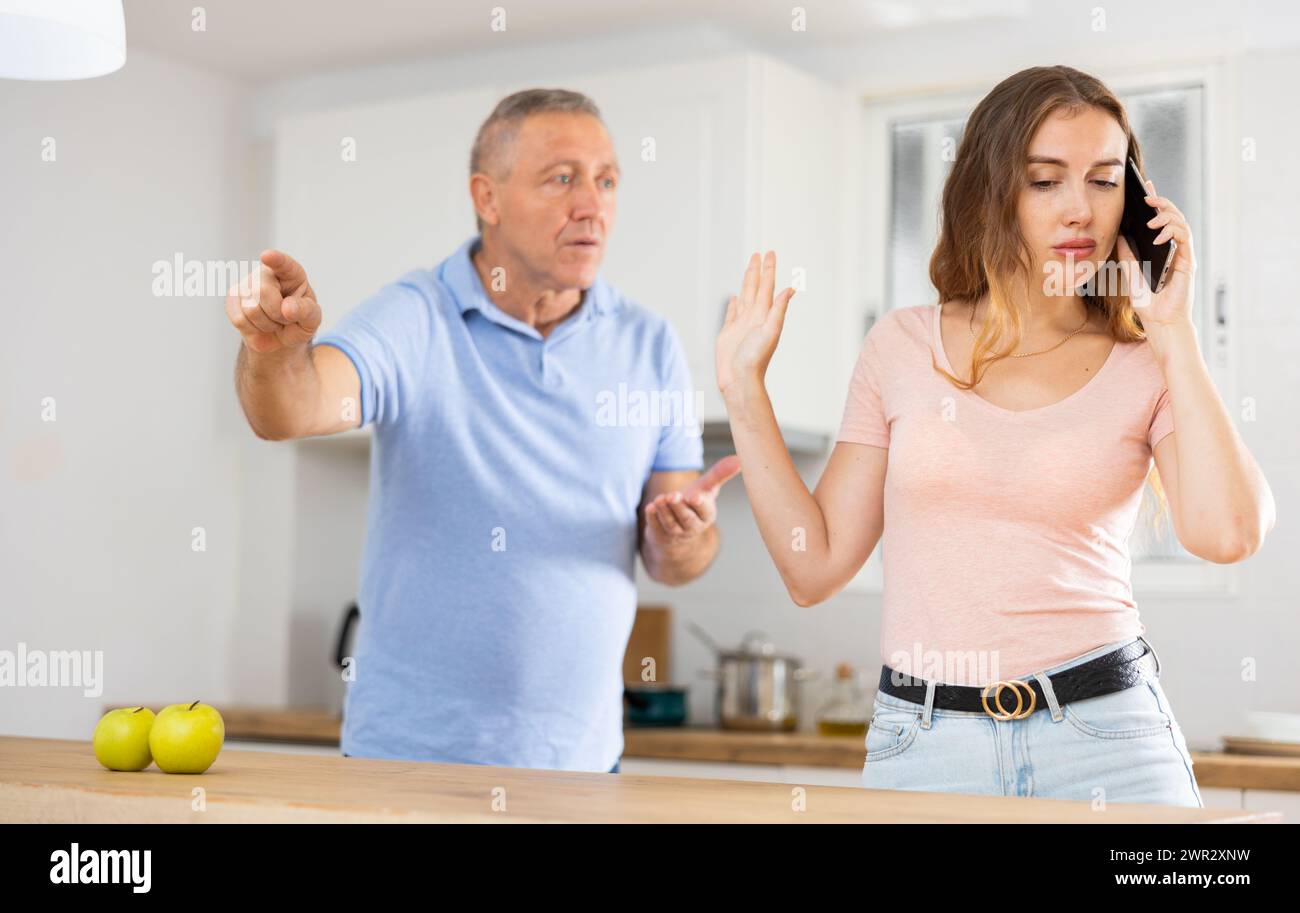 Daughter father scolding and yelling at her in home kitchen Stock Photo ...
