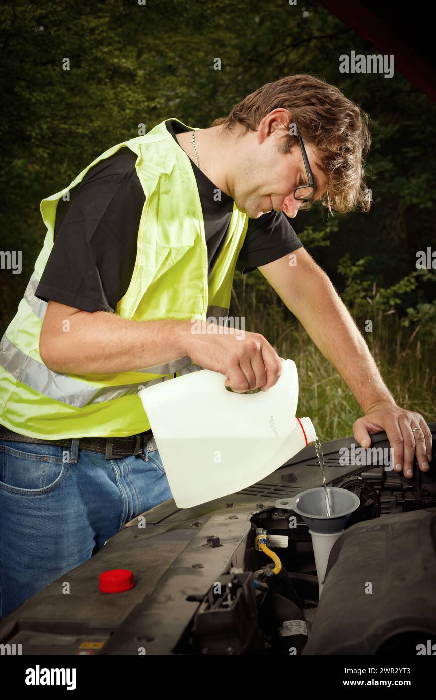 Car driver take care of his car before longer trip Stock Photo - Alamy