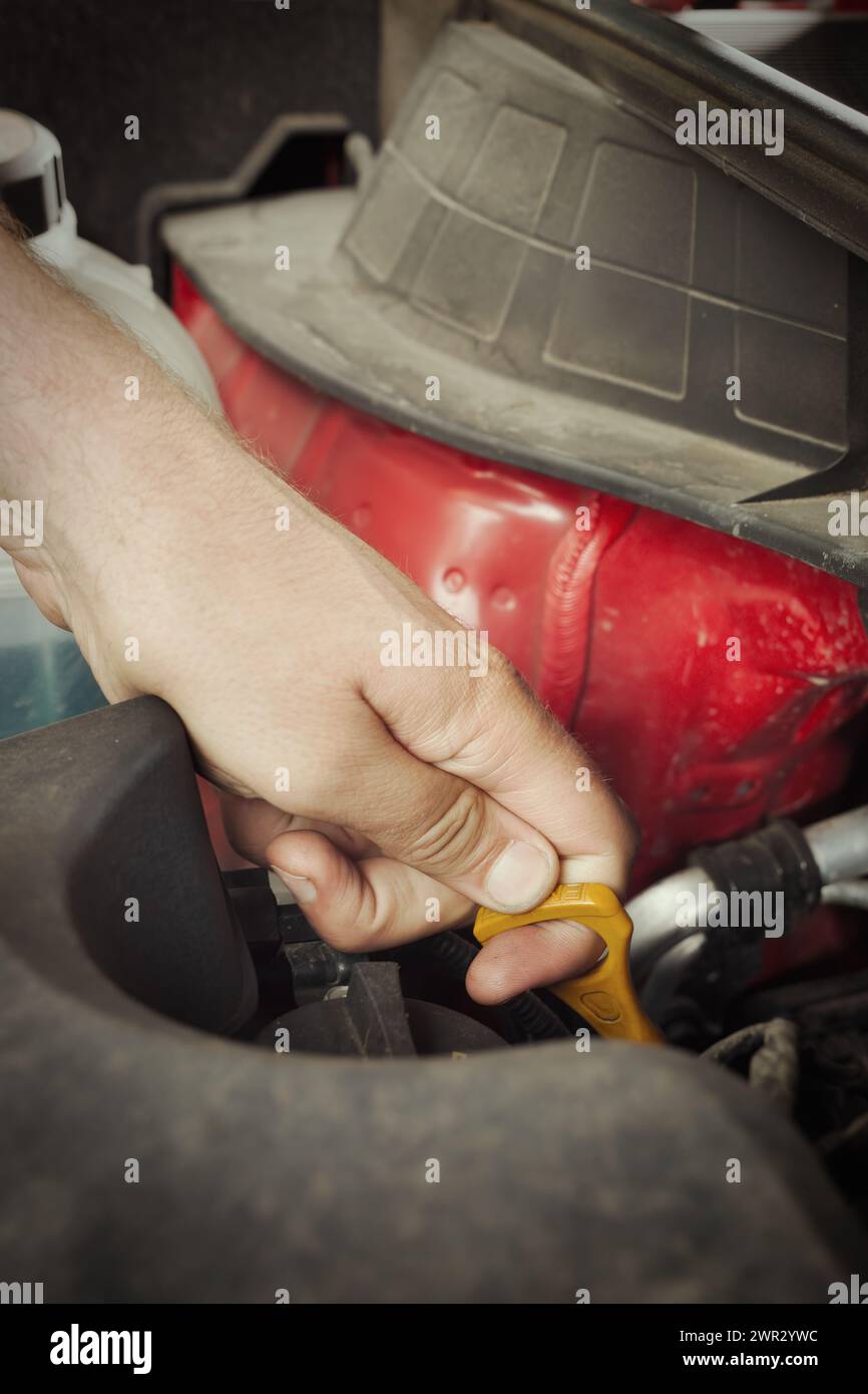 Car driver take care of his car before longer trip and checking oil ...