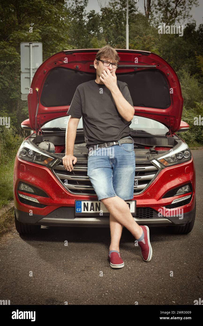Car driver after taking care of his car before longer trip Stock Photo ...