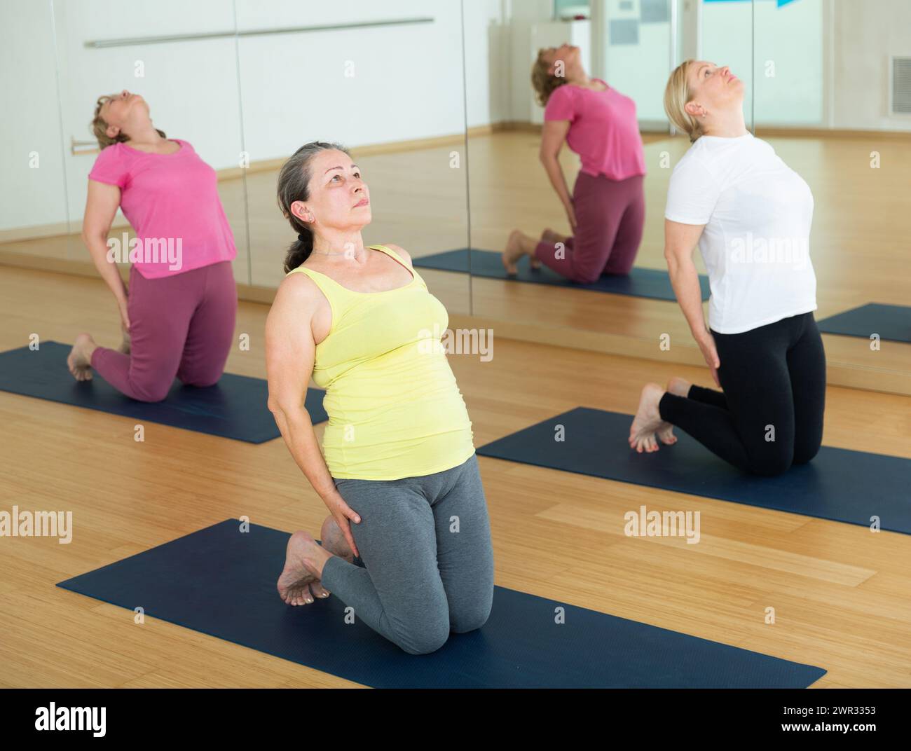 Women are doing camel pose Stock Photo - Alamy