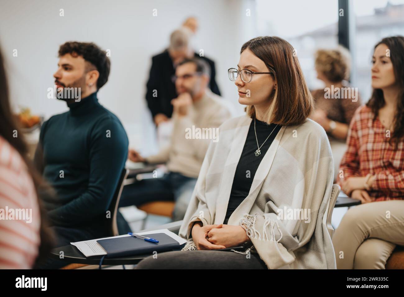 Focused audience listening in conference room during professional ...