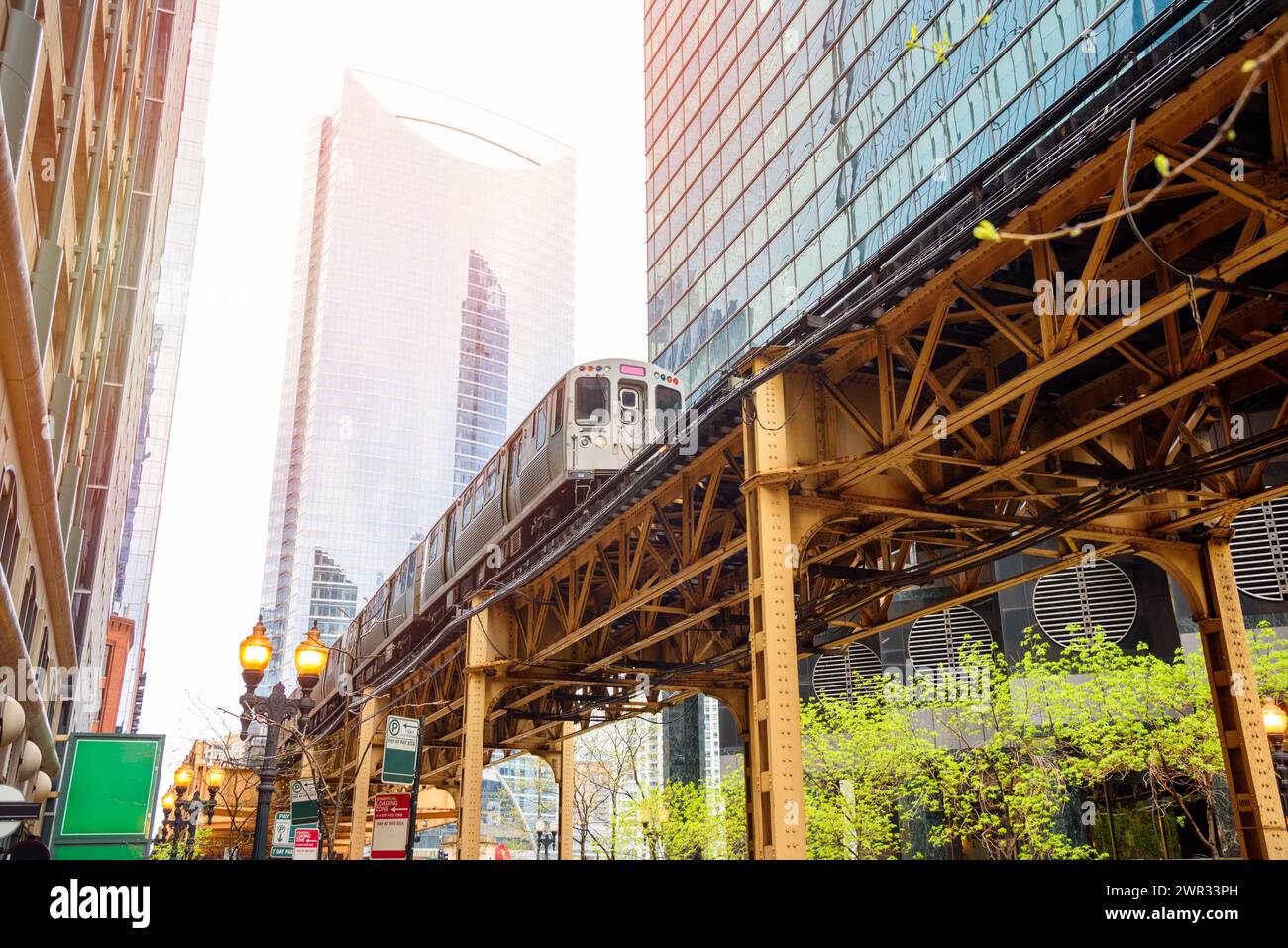 Elevated commuter train running through Chicago Loop on a spring day ...