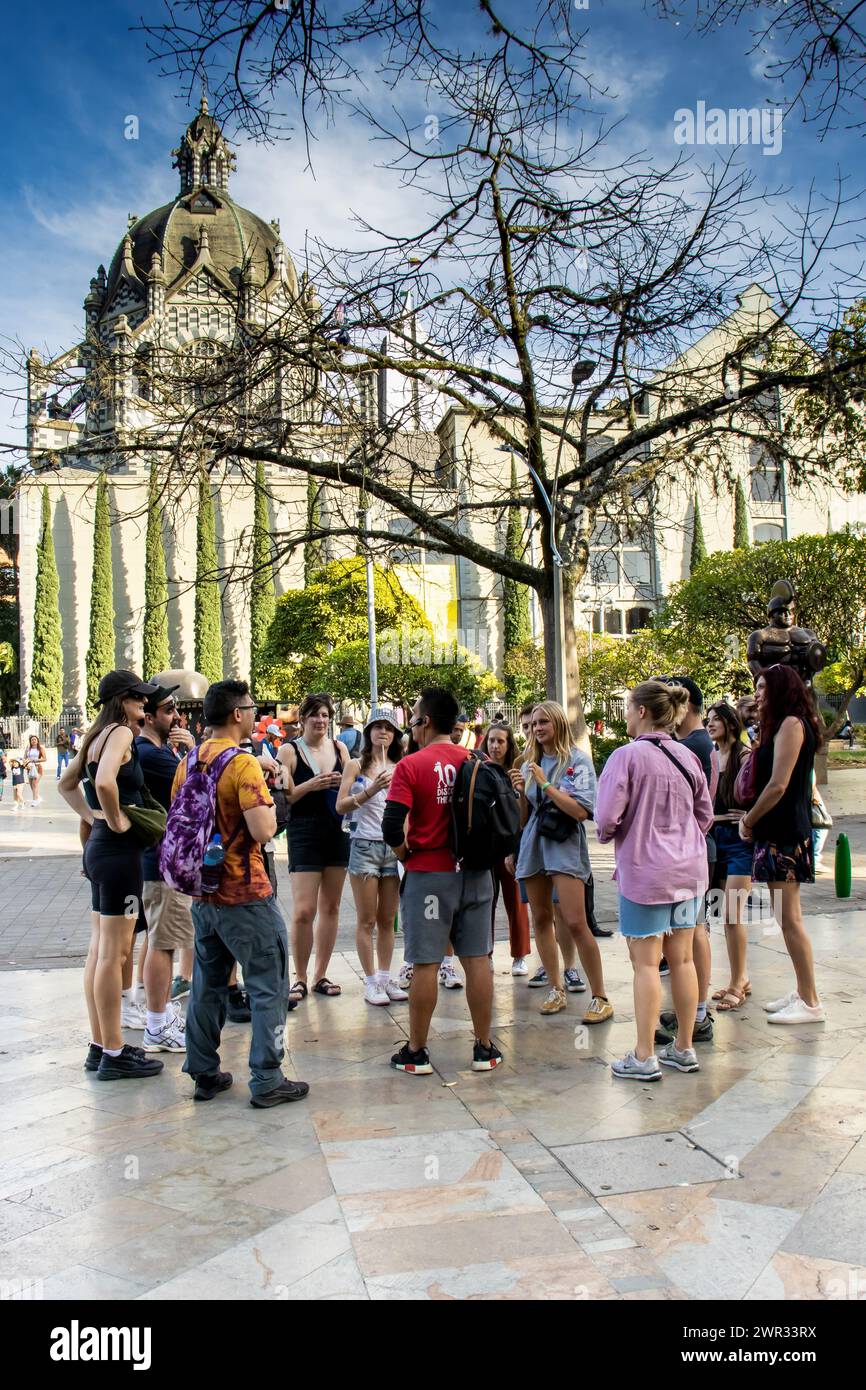 MEDELLIN, COLOMBIA - JANUARY 17, 2024: Foreing tourists with a tour ...