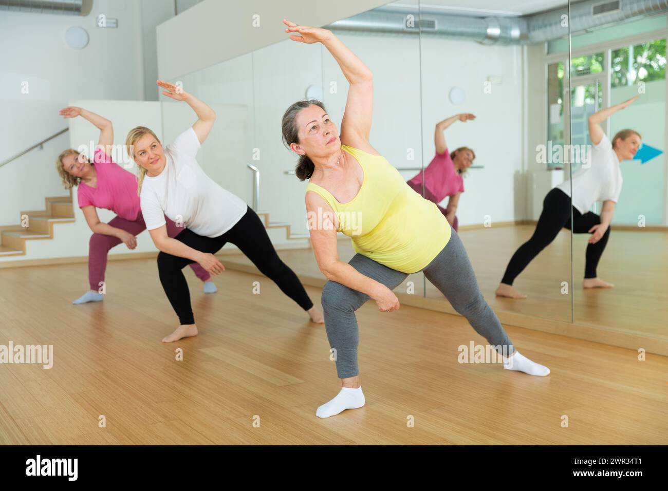 Three women are exercising in a gym Stock Photo - Alamy