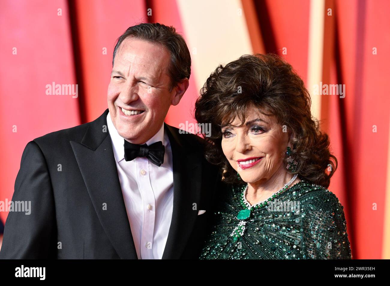 Percy Gibson, left, and Joan Collins arrive at the Vanity Fair Oscar ...