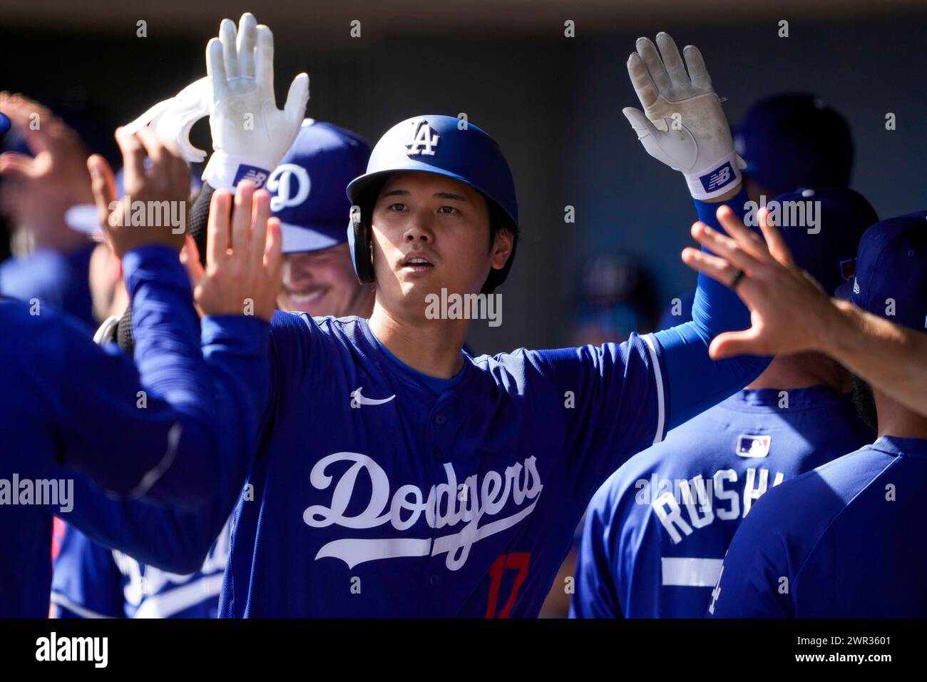 Los Angeles Dodgers designated hitter Shohei Ohtani is greeted by ...
