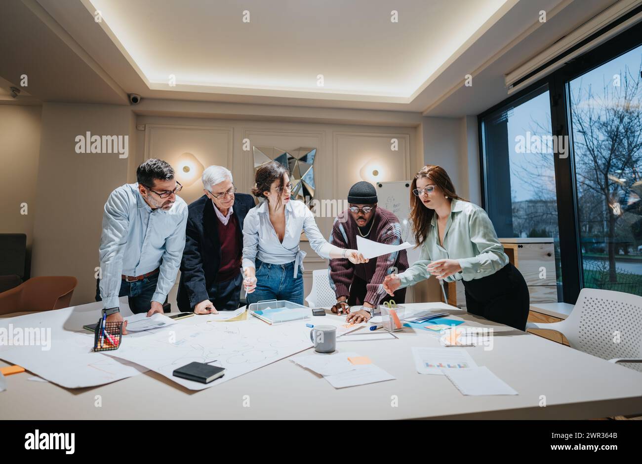 Cross generational, business team of colleagues engaging in a strategic ...