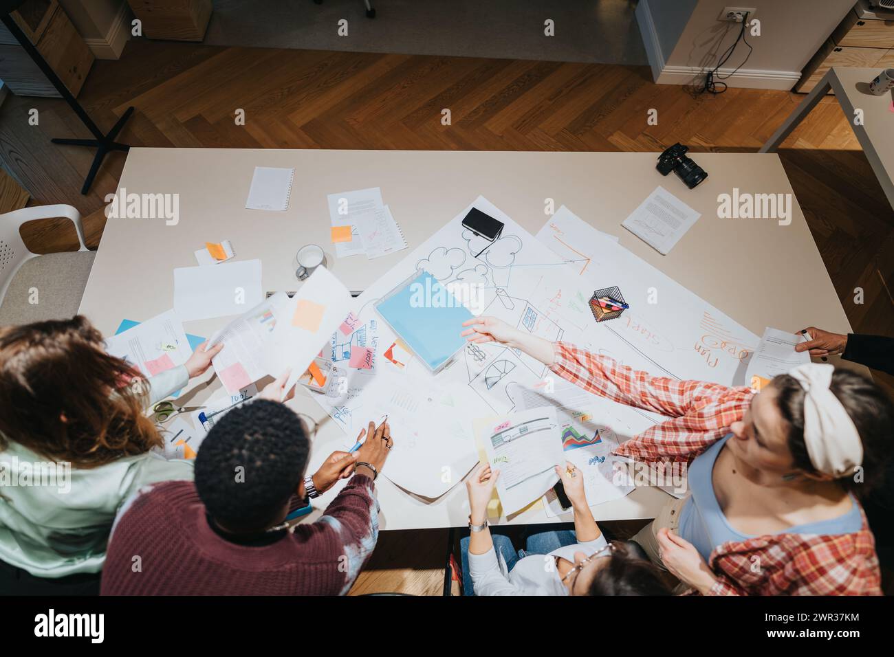 A multigenerational team of employees are actively engaged in a ...