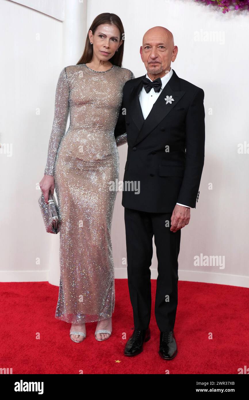 Daniela Lavender, left, and Ben Kingsley arrives at the Oscars on Sunday, March 10, 2024, at the ...