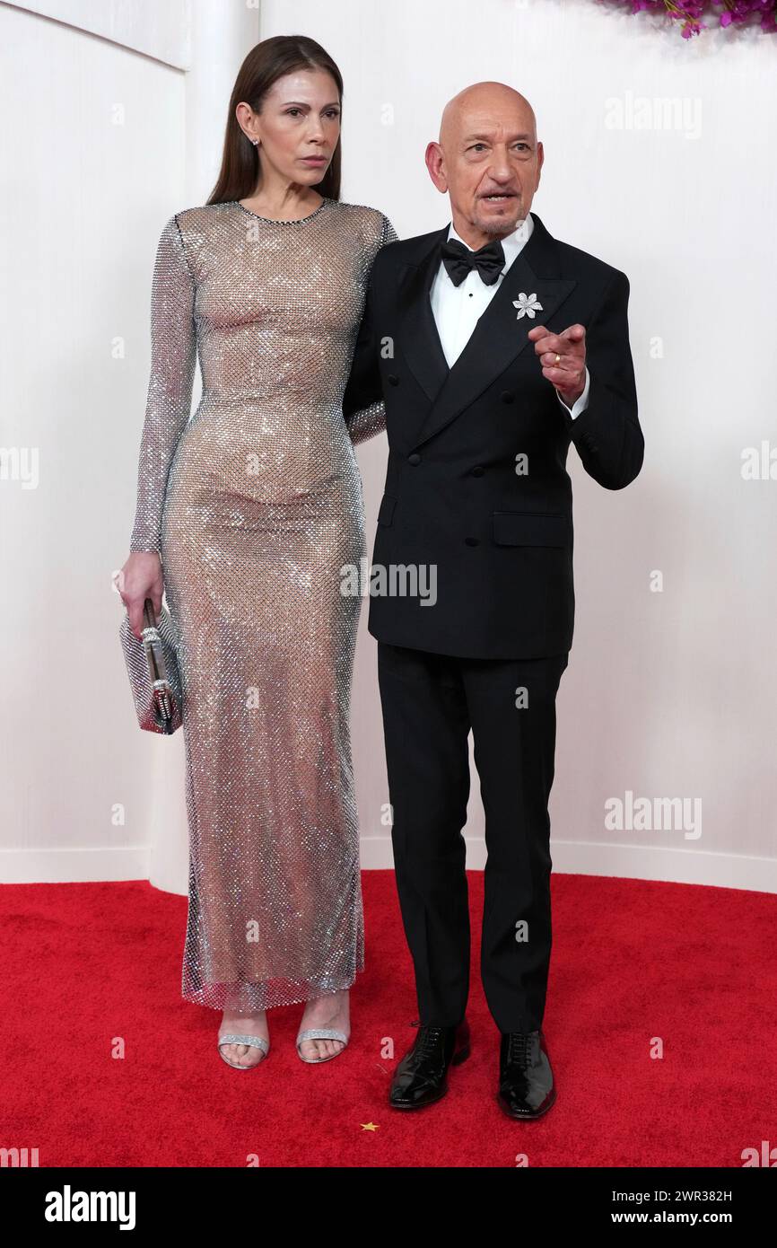 Daniela Lavender, left, and Ben Kingsley arrives at the Oscars on Sunday, March 10, 2024, at the ...