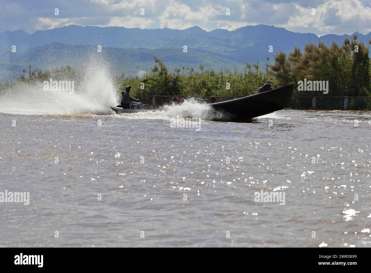 Fast boat travelling at high speed on a river and creating splashing ...