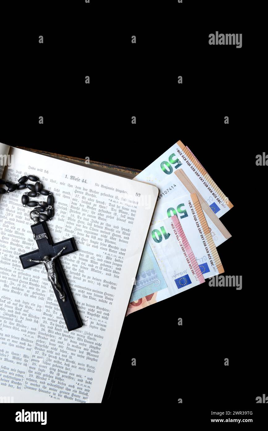 Bible, crucifix and banknotes, church and money, church tax Stock Photo ...