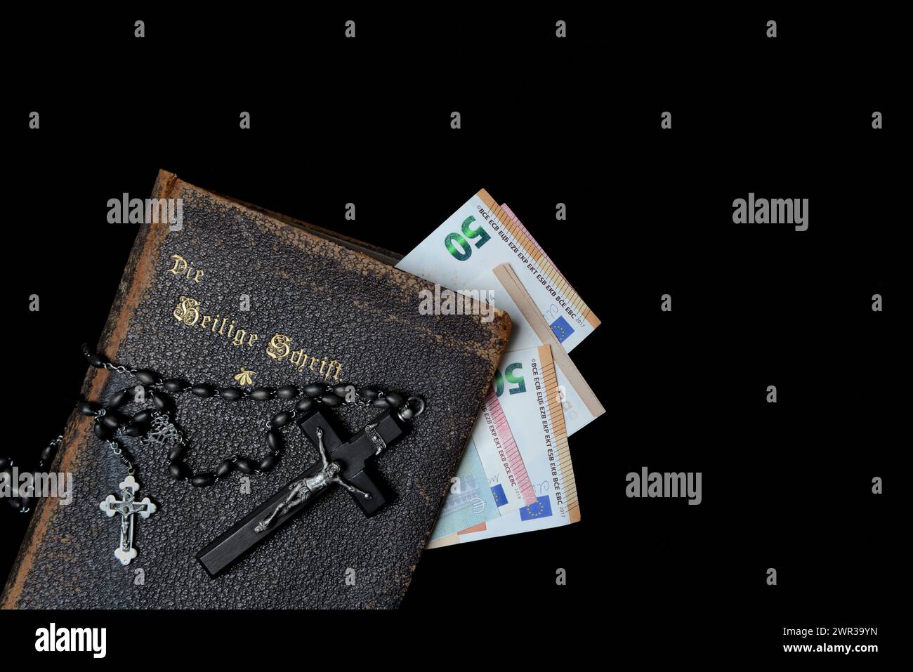 Bible, crucifix and banknotes, church and money, church tax Stock Photo ...