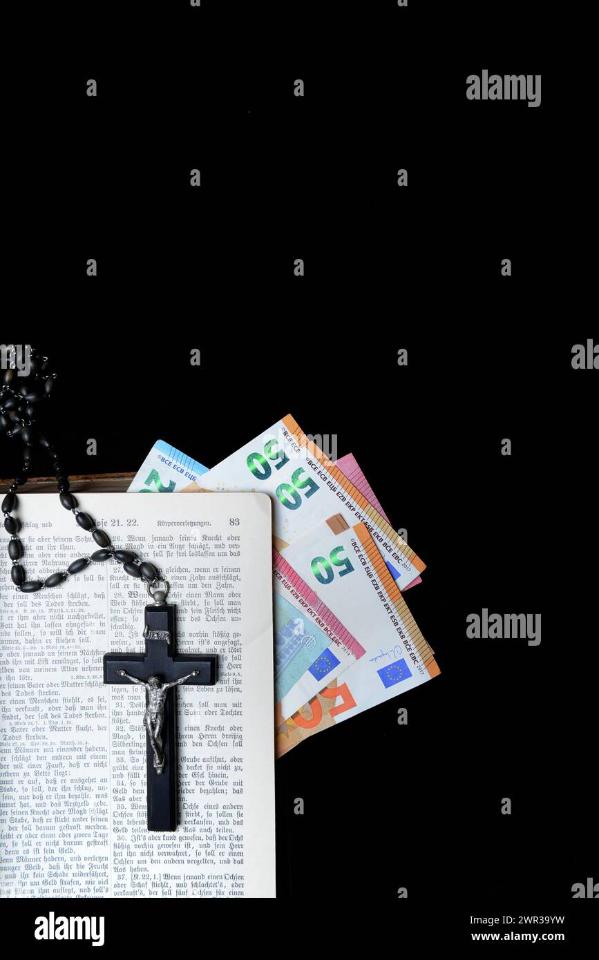 Bible, crucifix and banknotes, church and money, church tax Stock Photo ...